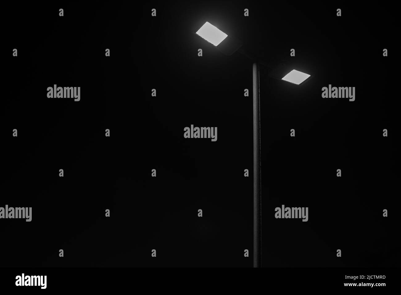 one single street light with black background Stock Photo - Alamy