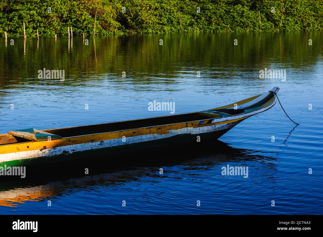 Canoes and boats docked on the Jaguaripe River in Maragogipinho ...