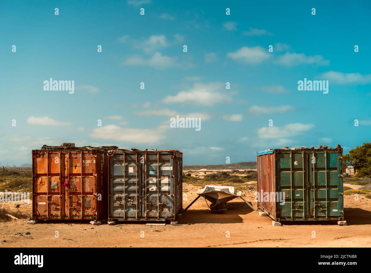 three containers and boat between them Stock Photo - Alamy