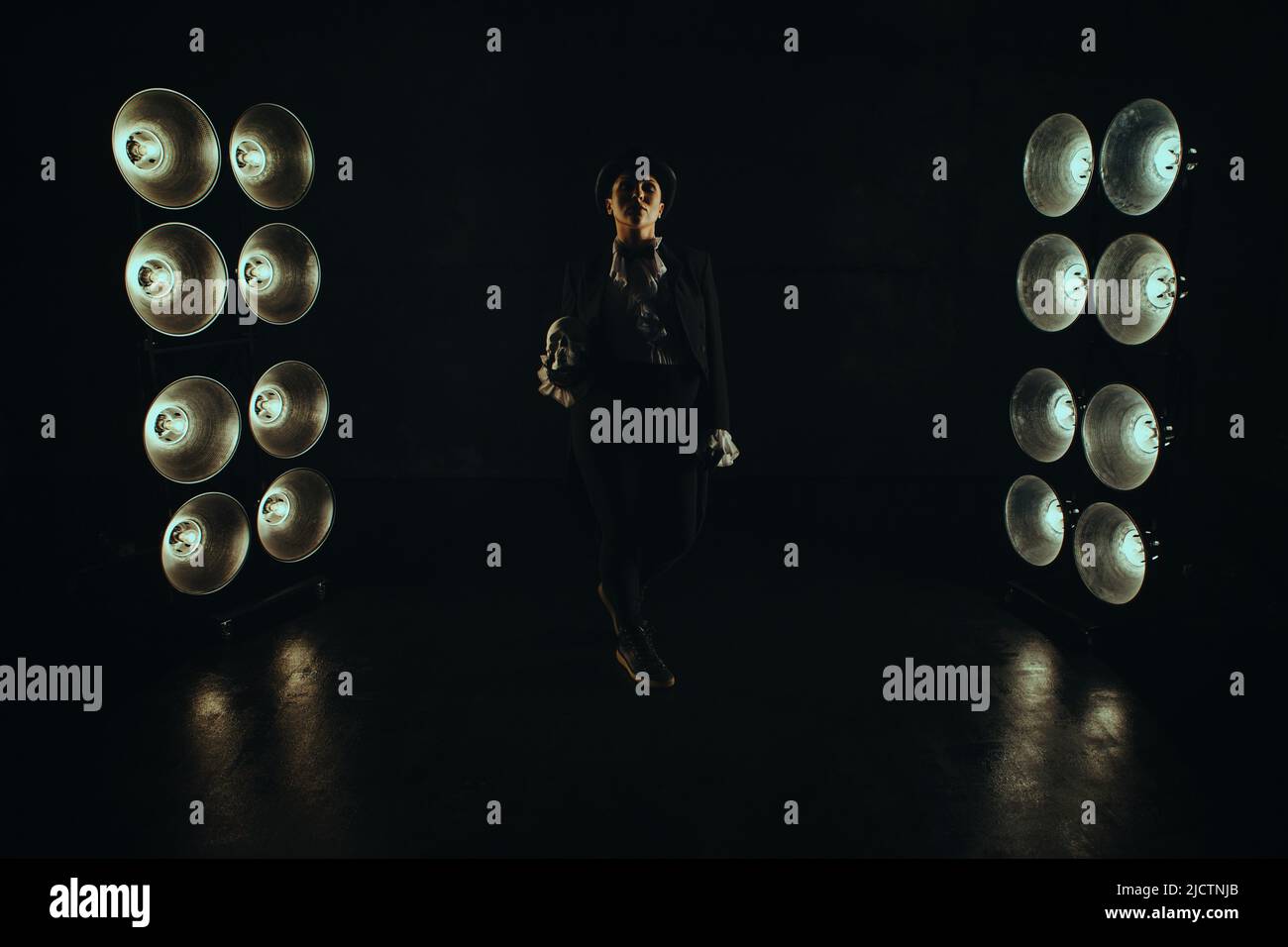 Pregnant girl in the image of a fat man against the background of lamps ...