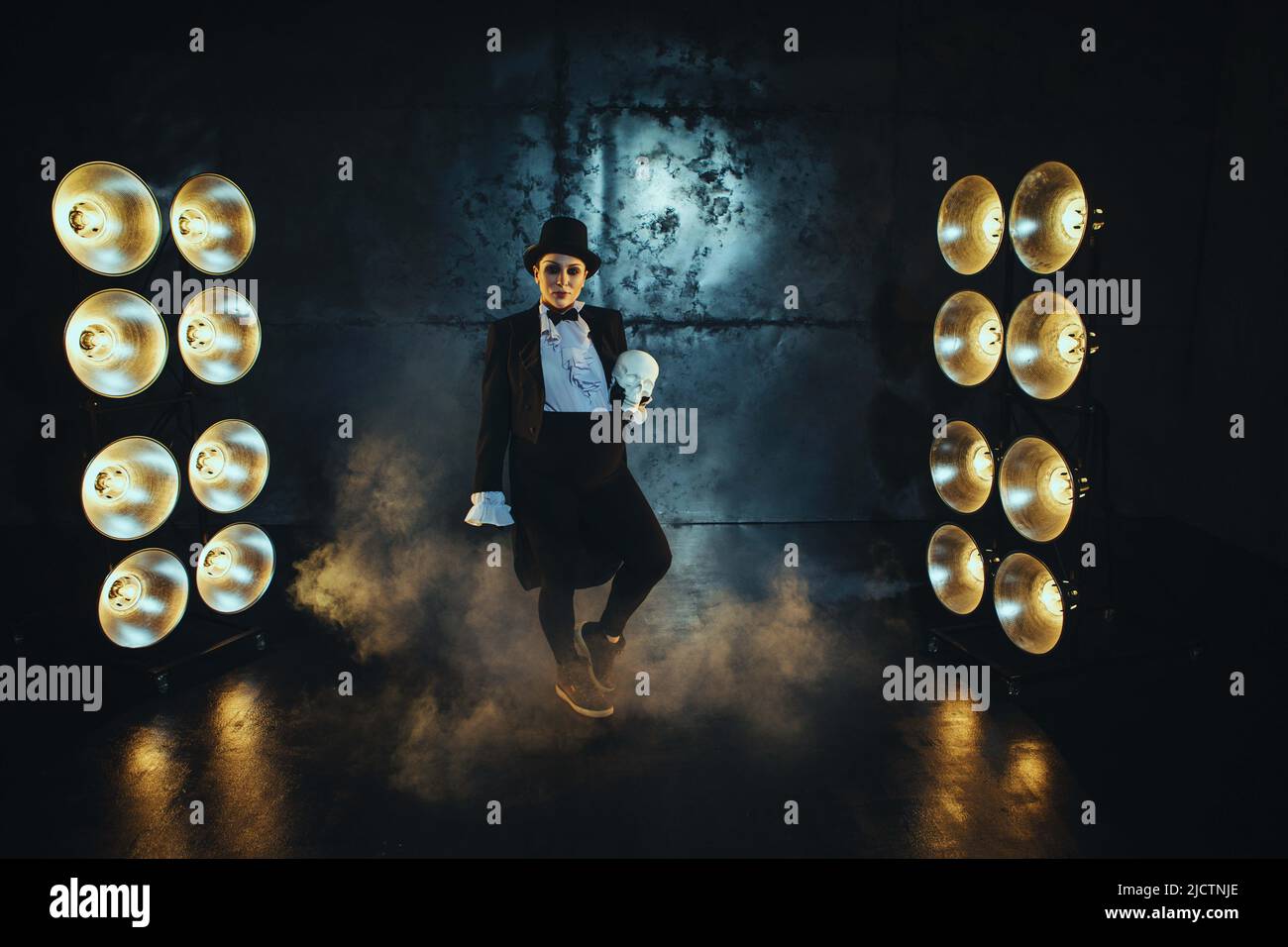 Pregnant girl in the image of a fat man against the background of lamps ...