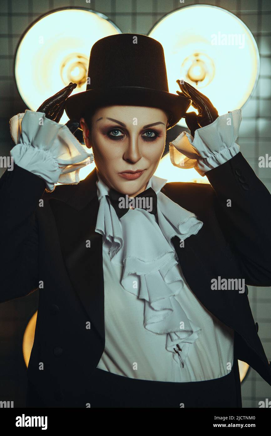 Pregnant girl in the image of a fat man against the background of lamps ...