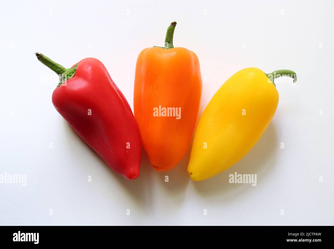 A Trio of Small Colorful Peppers on a White Background Stock Photo - Alamy