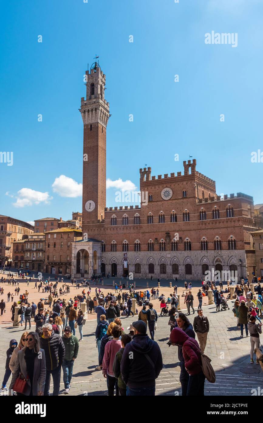 Siena, Italy, 17 April 2022: tourists enjoy Piazza del Campo square and ...