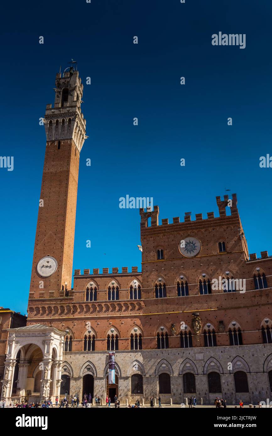 Siena, Italy, 17 April 2022: tourists enjoy Piazza del Campo square and ...