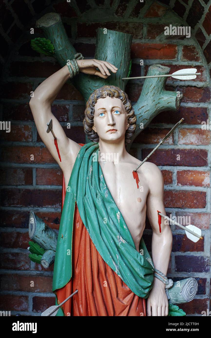 wooden statue of jesus christ with arrows Stock Photo - Alamy