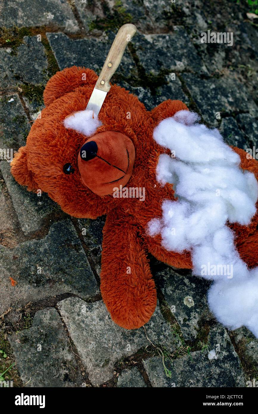adorable teddy bear lying on the floor destroyed with a knife Stock ...