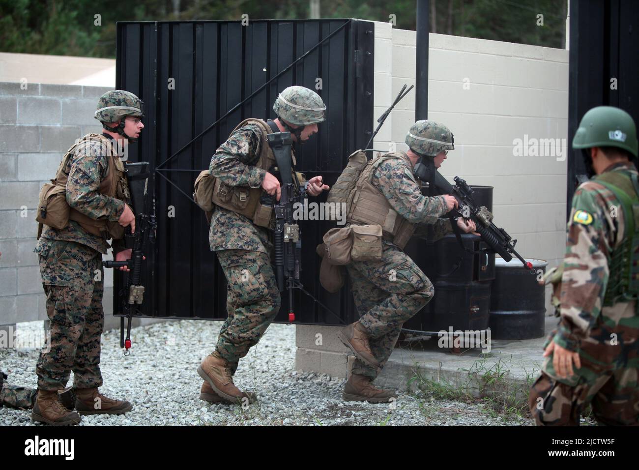 U.S. Marines with 1st Battalion, 8th Marine Regiment (1/8), 2D Marine Division, enter a house ...