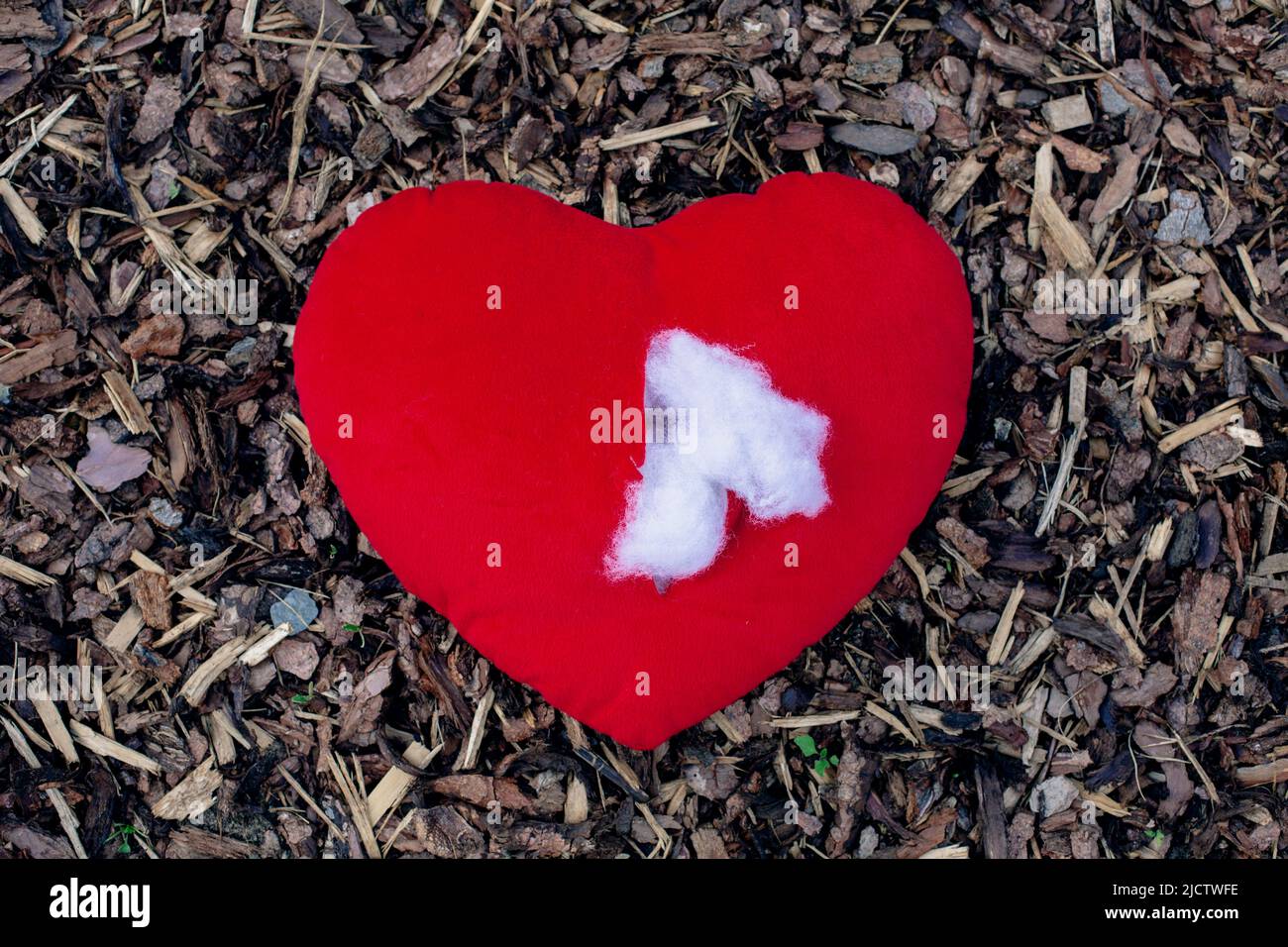 red ripped stuffed heart lying on the floor Stock Photo - Alamy