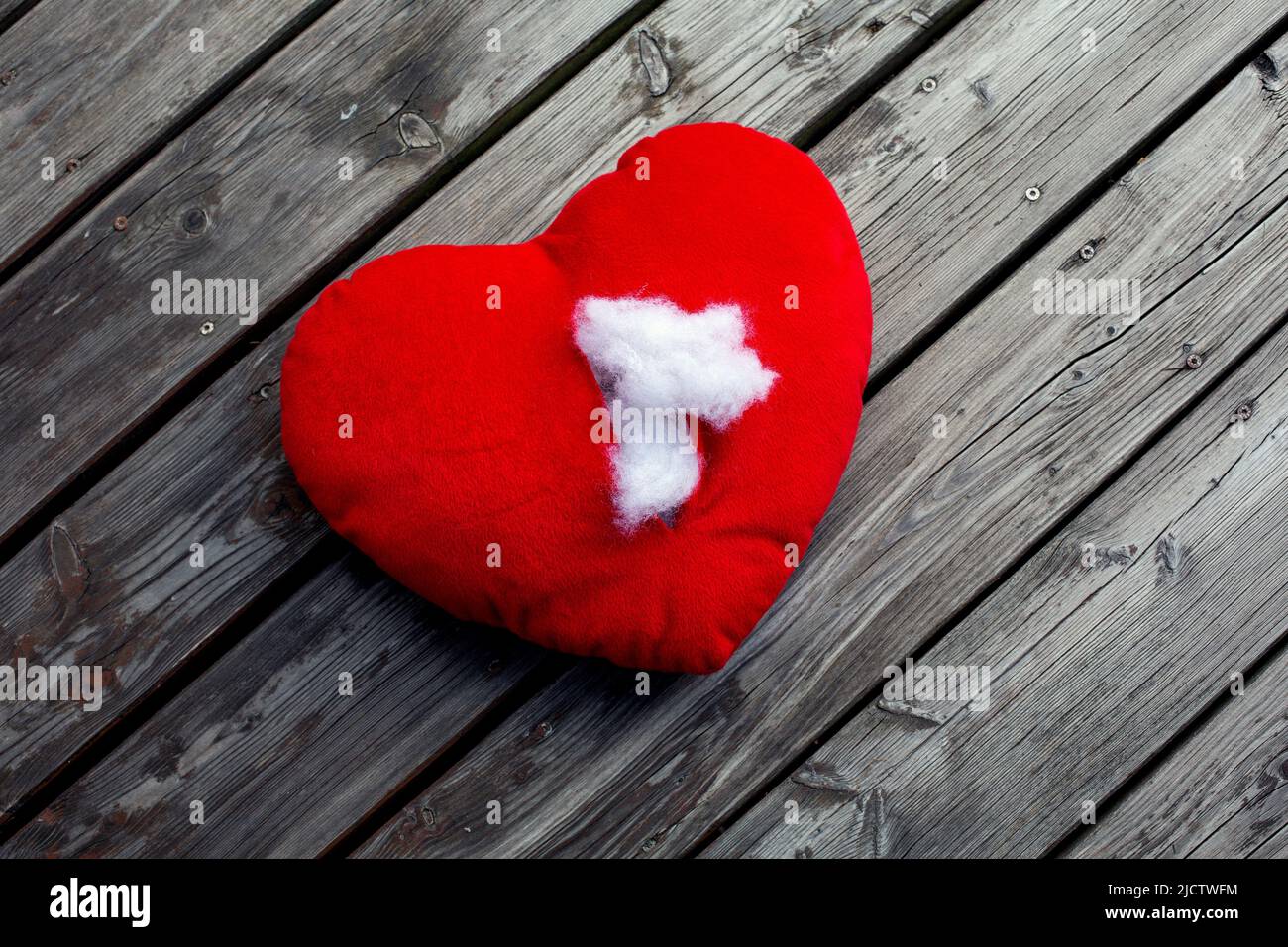 red ripped stuffed heart lying on the floor Stock Photo - Alamy