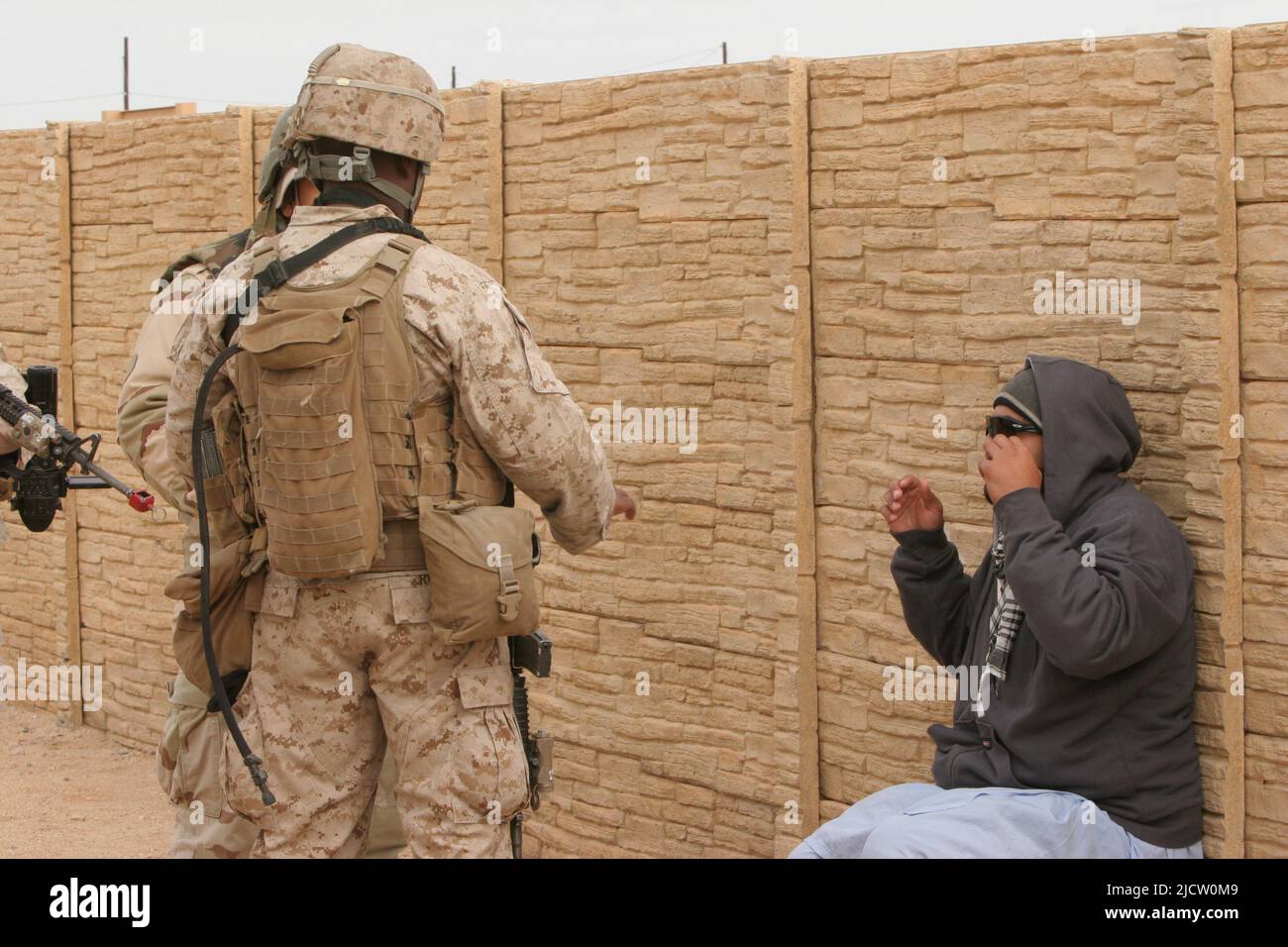 A civilian role player is being questioned by U.S. Marines with 1st ...