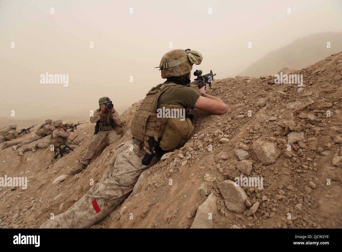 US Marines with 1st Battalion, 8th Marine Regiment return fire from ...