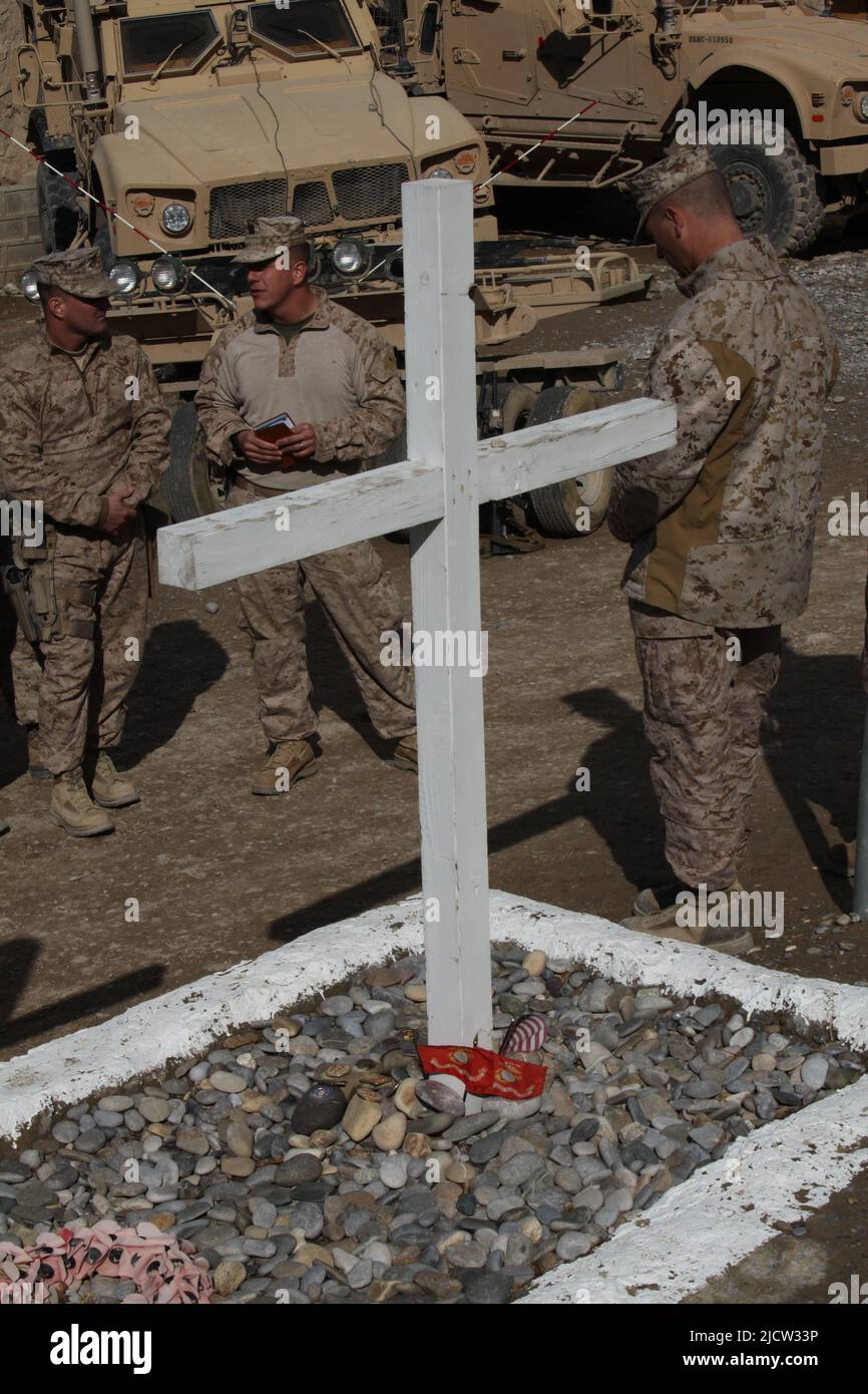 US Marines pay their respects to a fallen comrade's memorial while forward deployed to Kajaki ...