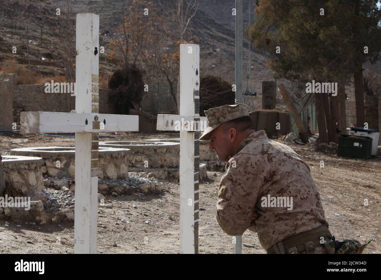 US Marines pay their respects to a fallen comrade's memorial while ...