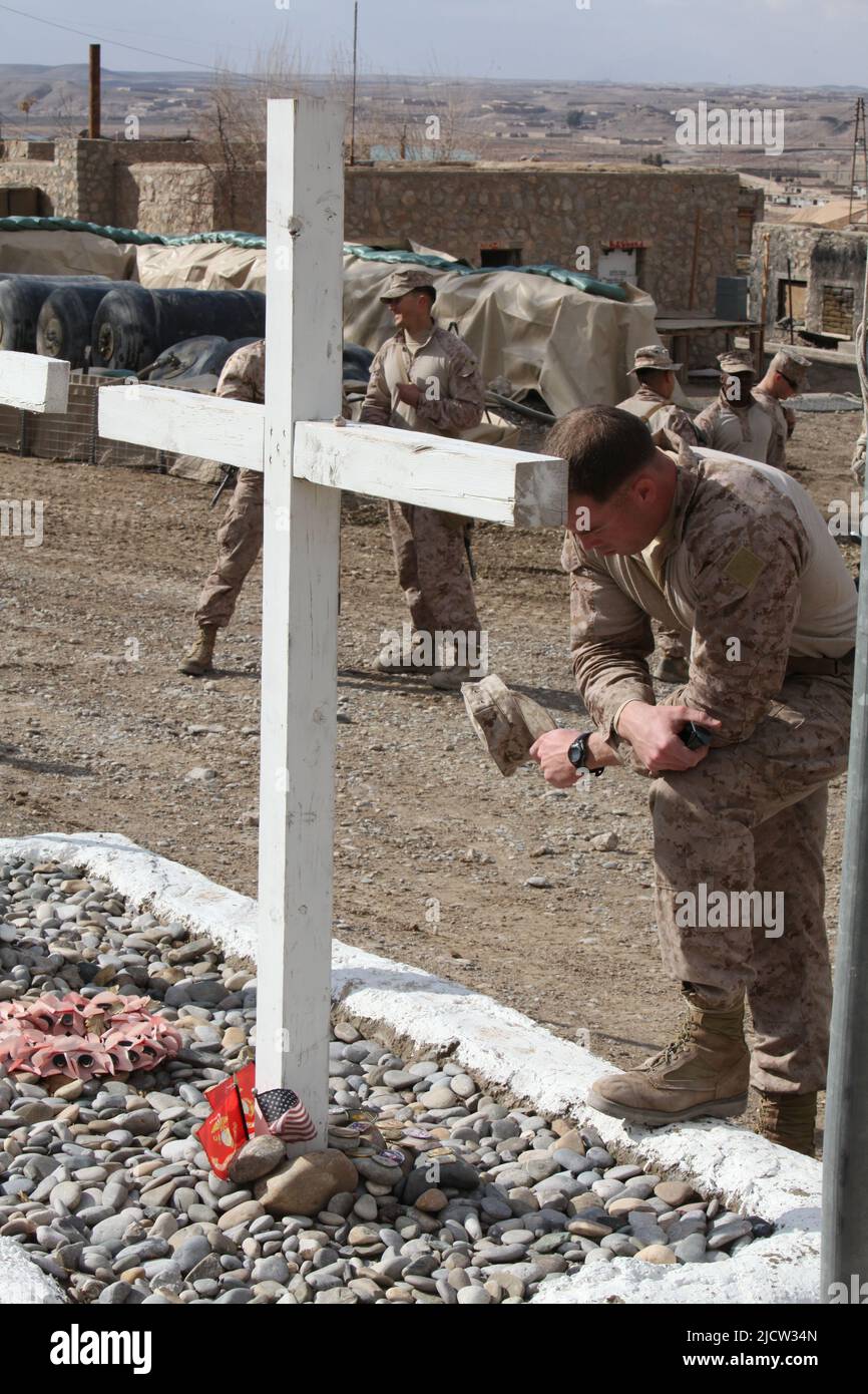US Marines pay their respects to a fallen comrade's memorial while ...