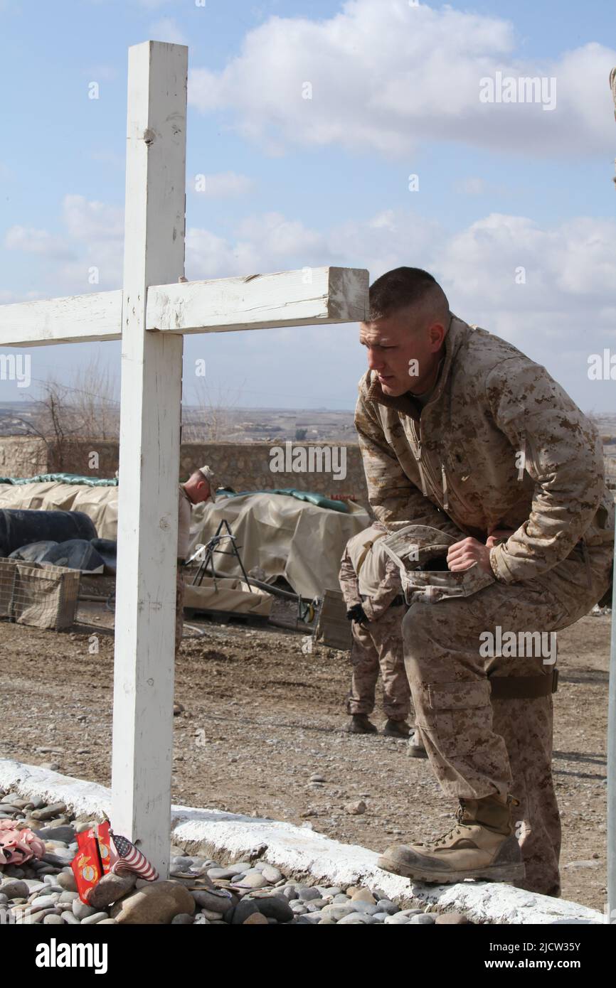 US Marines pay their respects to a fallen comrade's memorial while forward deployed to Kajaki ...