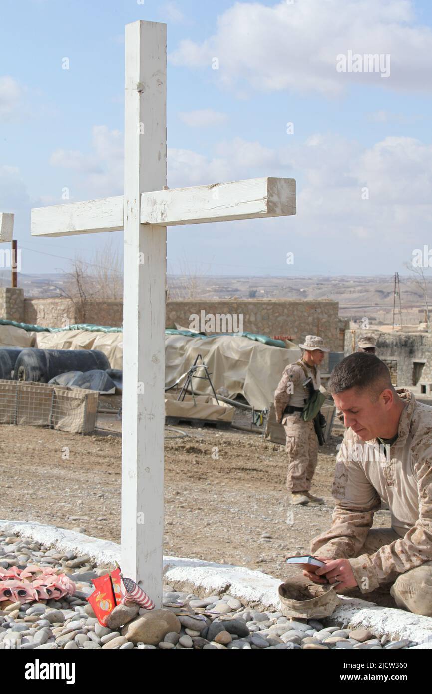 US Marines pay their respects to a fallen comrade's memorial while ...