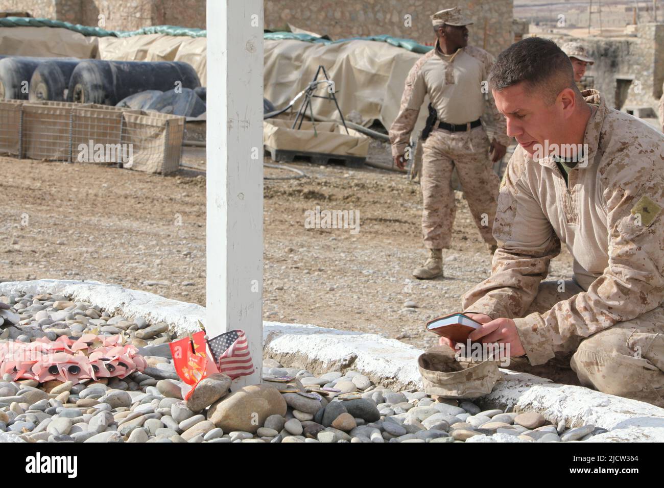 US Marines pay their respects to a fallen comrade's memorial while ...