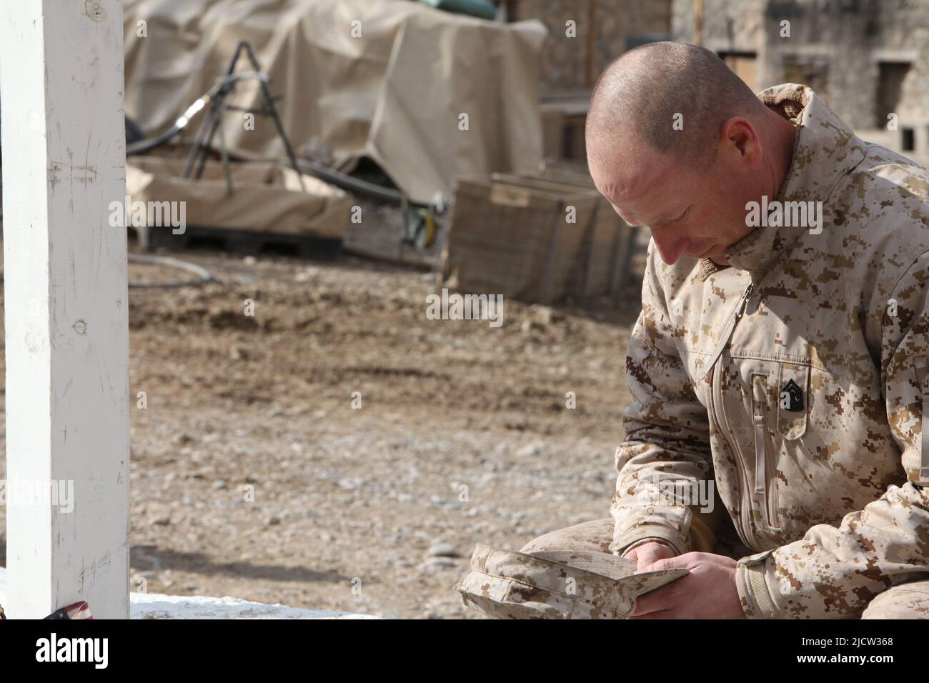 US Marines pay their respects to a fallen comrade's memorial while ...