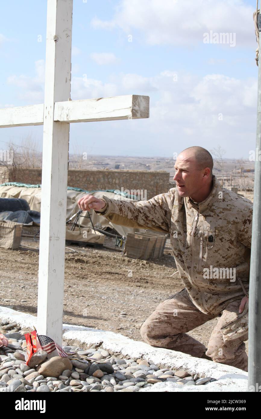 US Marines pay their respects to a fallen comrade's memorial while forward deployed to Kajaki ...