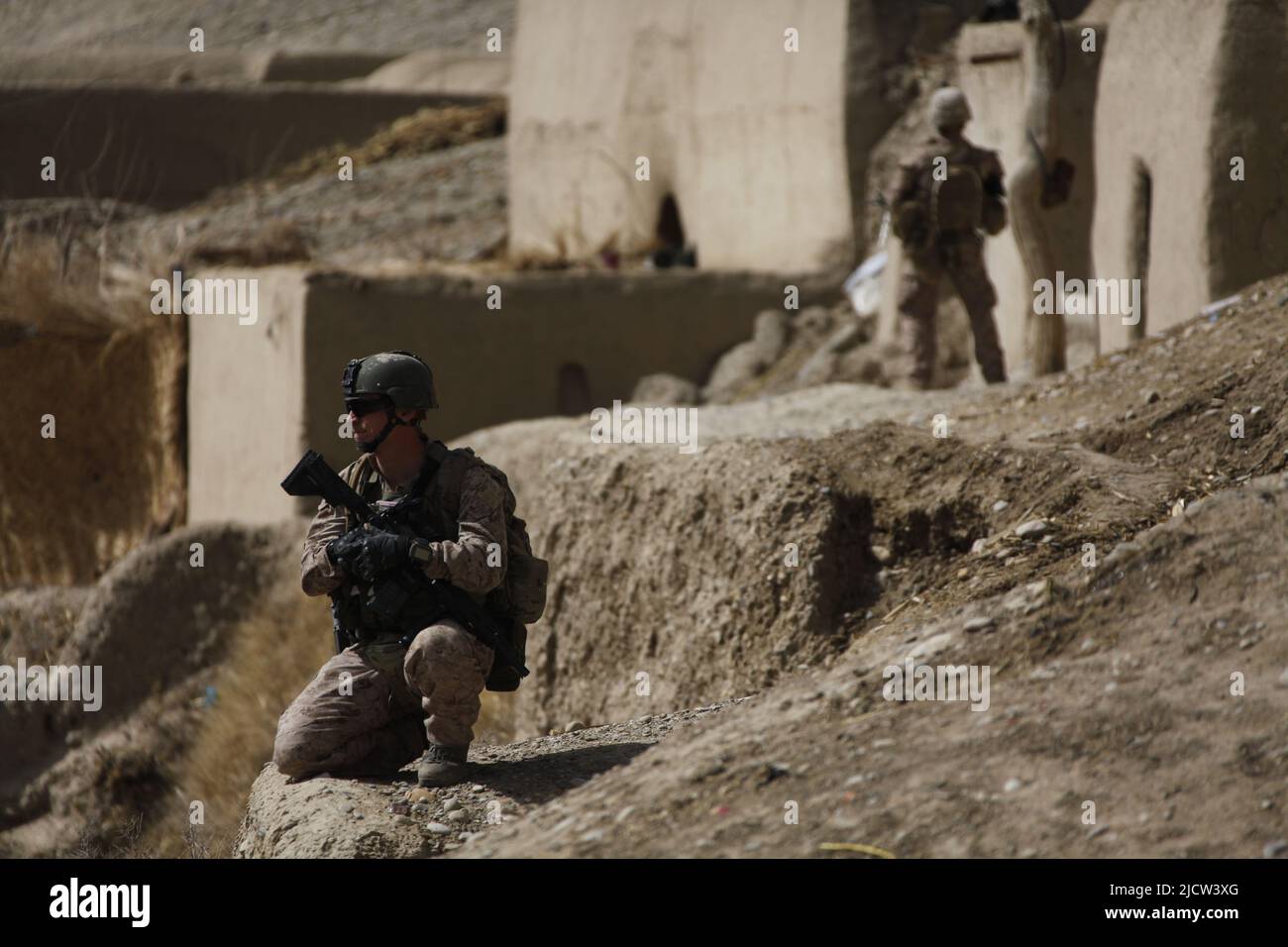 British Royal Marine Commando Lance Cpl. Alan Cahill (left), provides ...