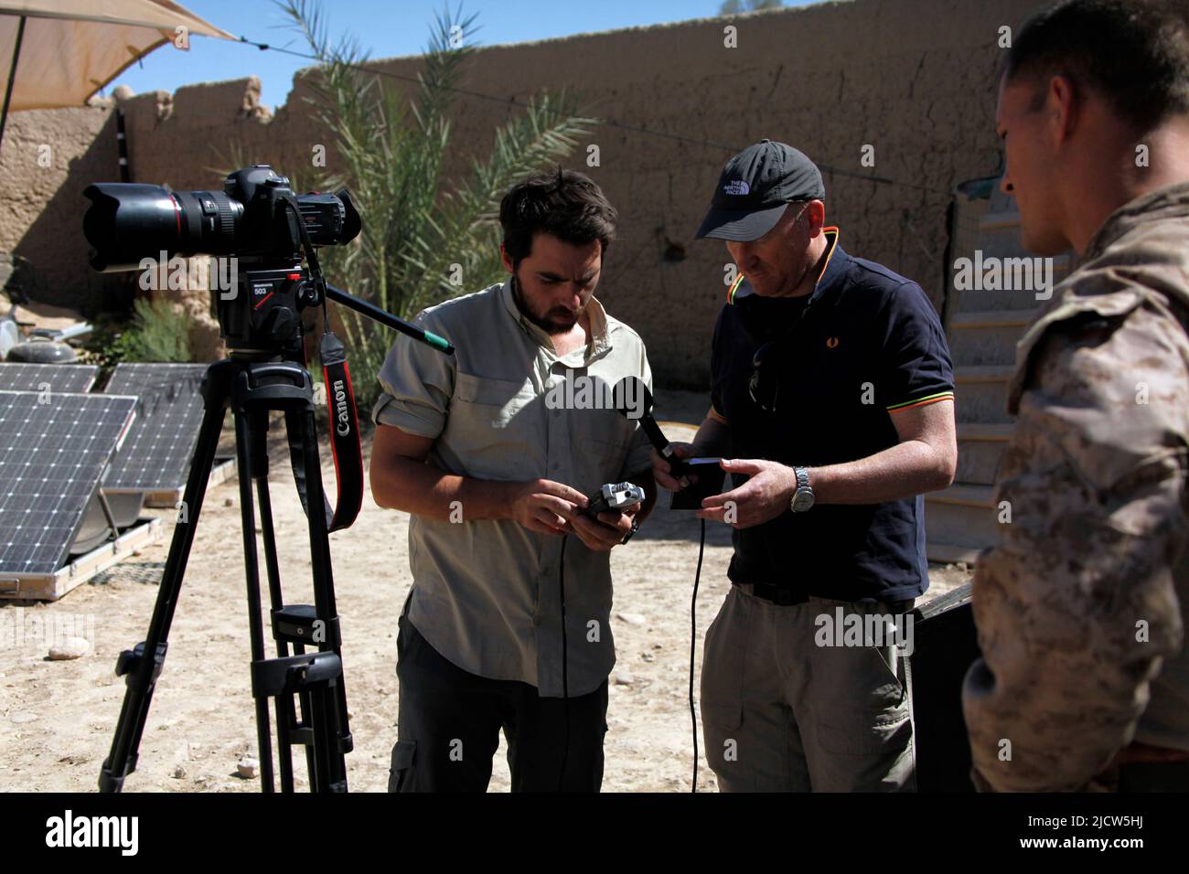 Ben Foley, left, camera man, and Bernard Smith, center, reporter, with Al Jazeera English News ...