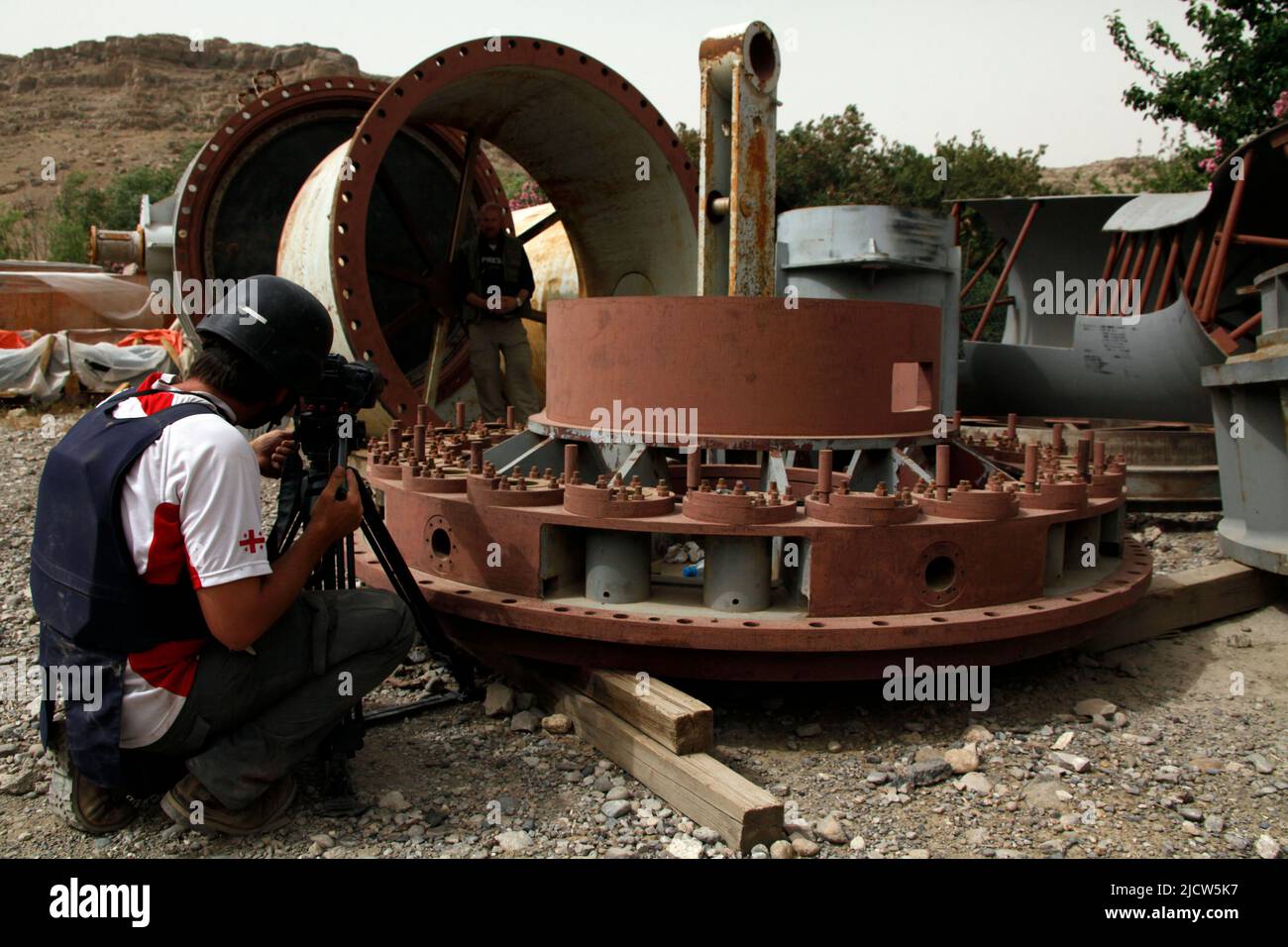 Bernard Smith, center, reporter, and Ben Foley, left, cameraman, with ...