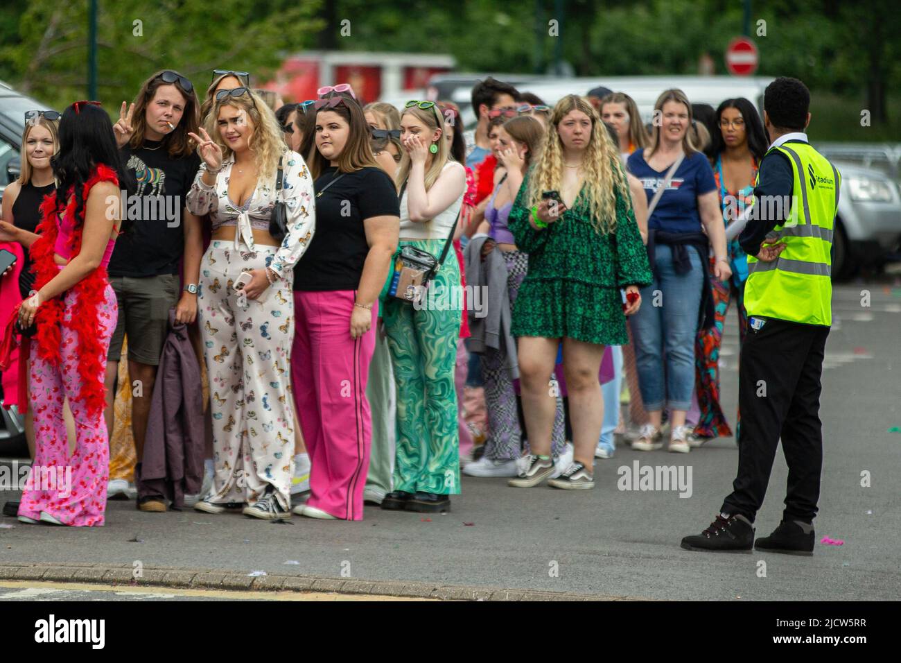 Fans queue up as they wait to head into the venue. Harry Styles fans ...