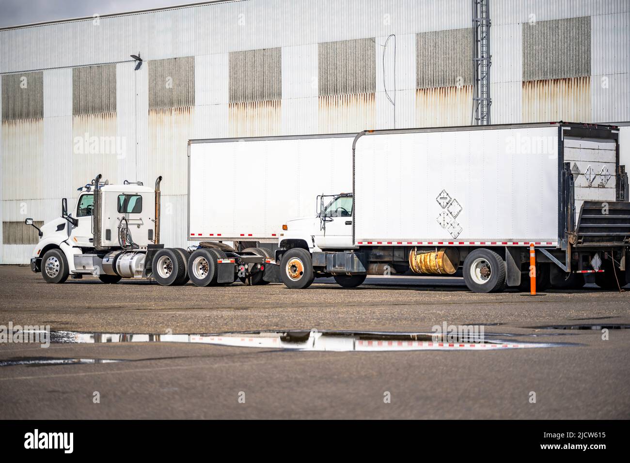 Big rig day cab semi truck with dry van semi trailer and small rig ...