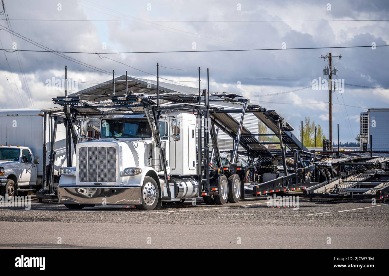 Unloaded big rig white car hauler semi truck tractor with empty modular ...