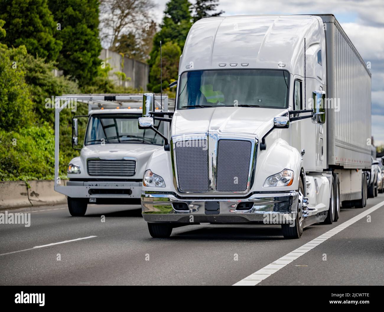 Loaded classic big rig white semi truck tractor transporting commercial ...