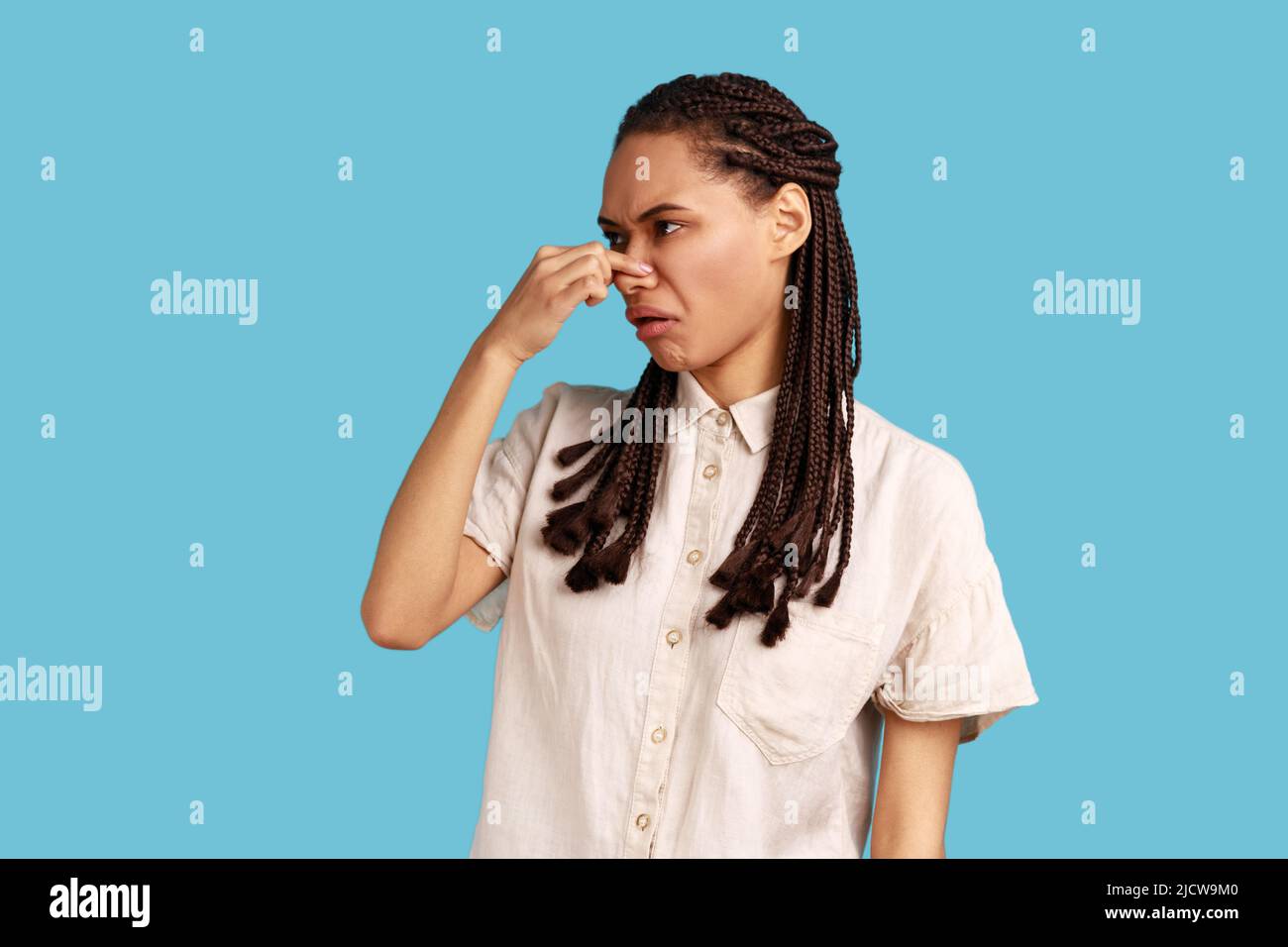 Stink, awful odor. Woman with black dreadlocks pinching nose, stop ...