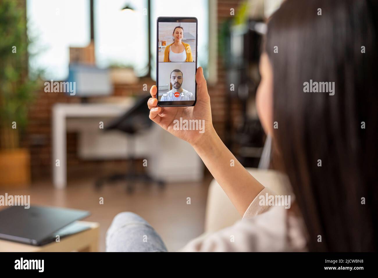 Authentic busy asian woman on video call meeting online communication workign from home. talking ...