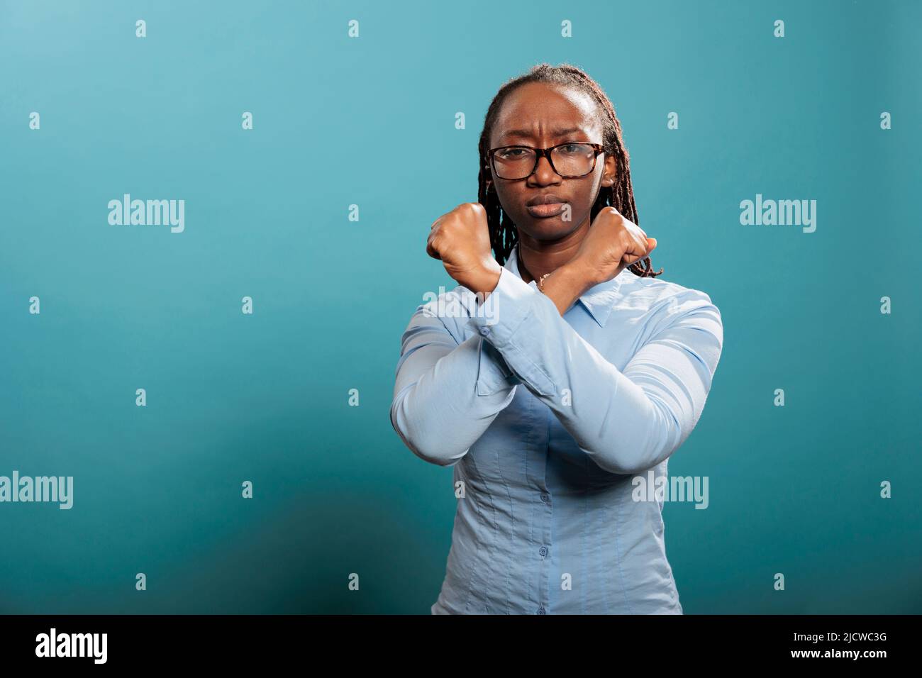 Disapproving african american woman making stop gesture with crossed ...