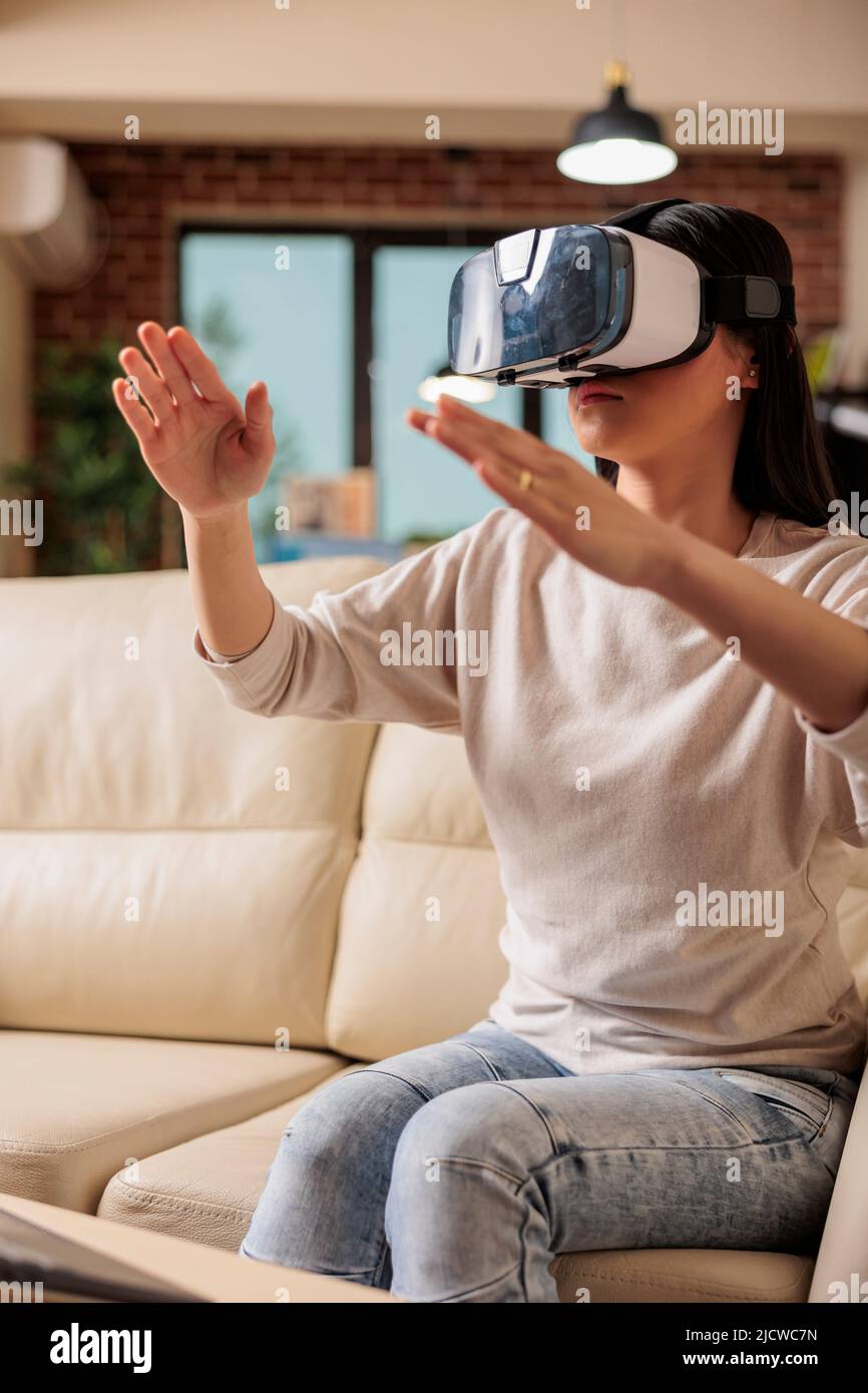 Happy asian woman enjoying wearing VR virtual reality headset, modern ...