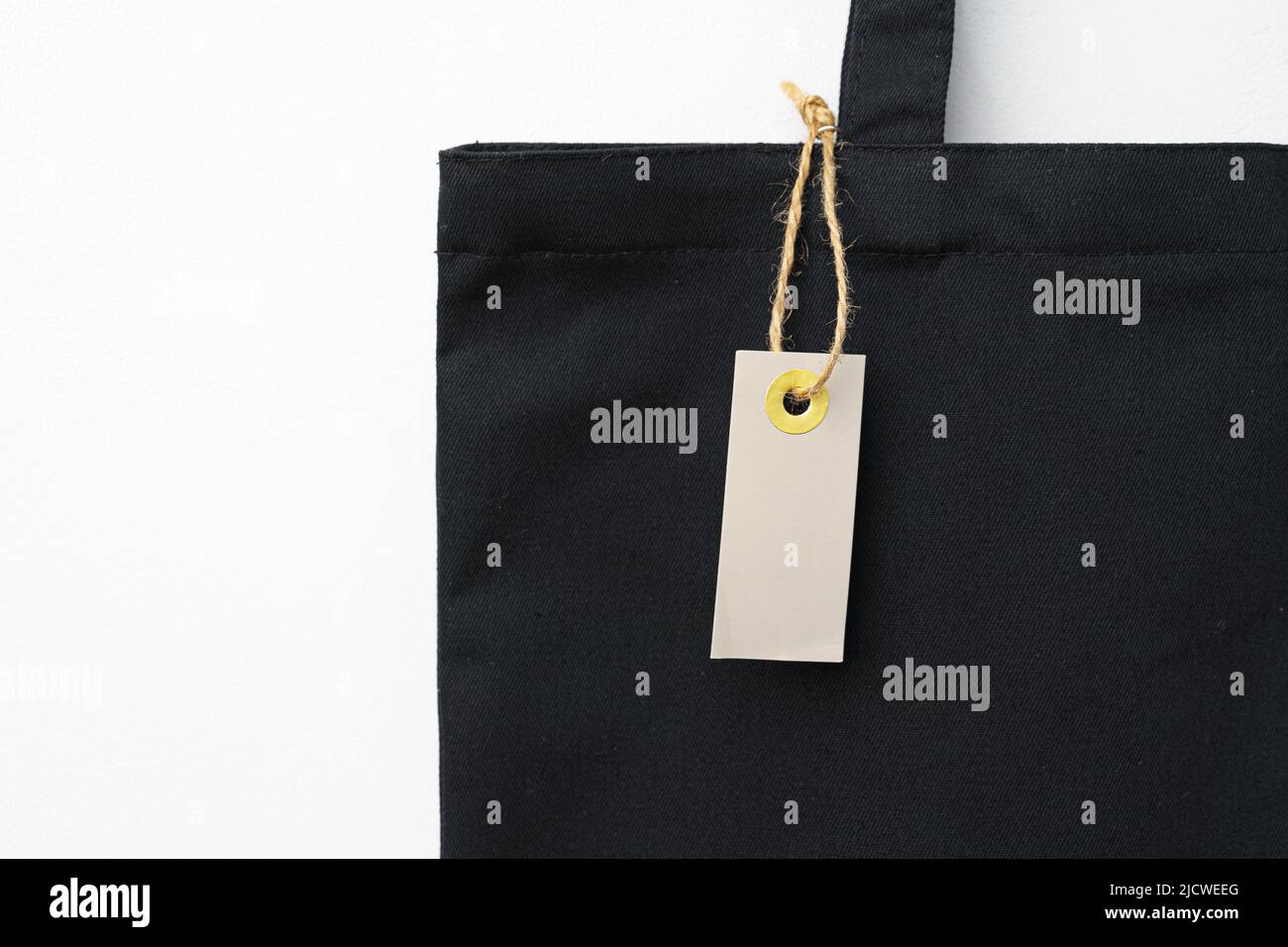 Eco bag for shopping with blank tag on white background Stock Photo - Alamy