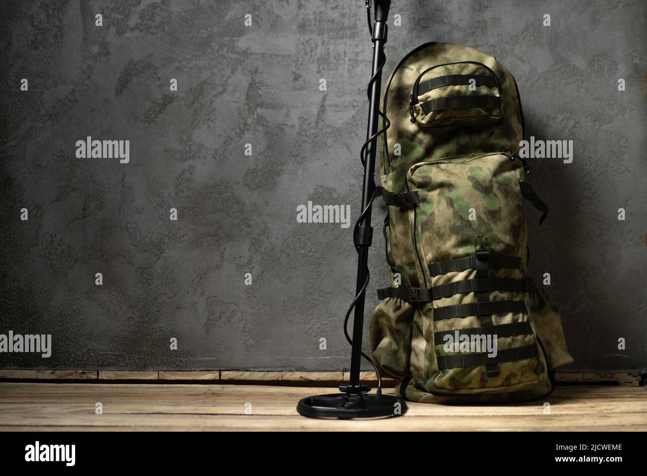 Metal detector and backpack on dark gray background Stock Photo - Alamy