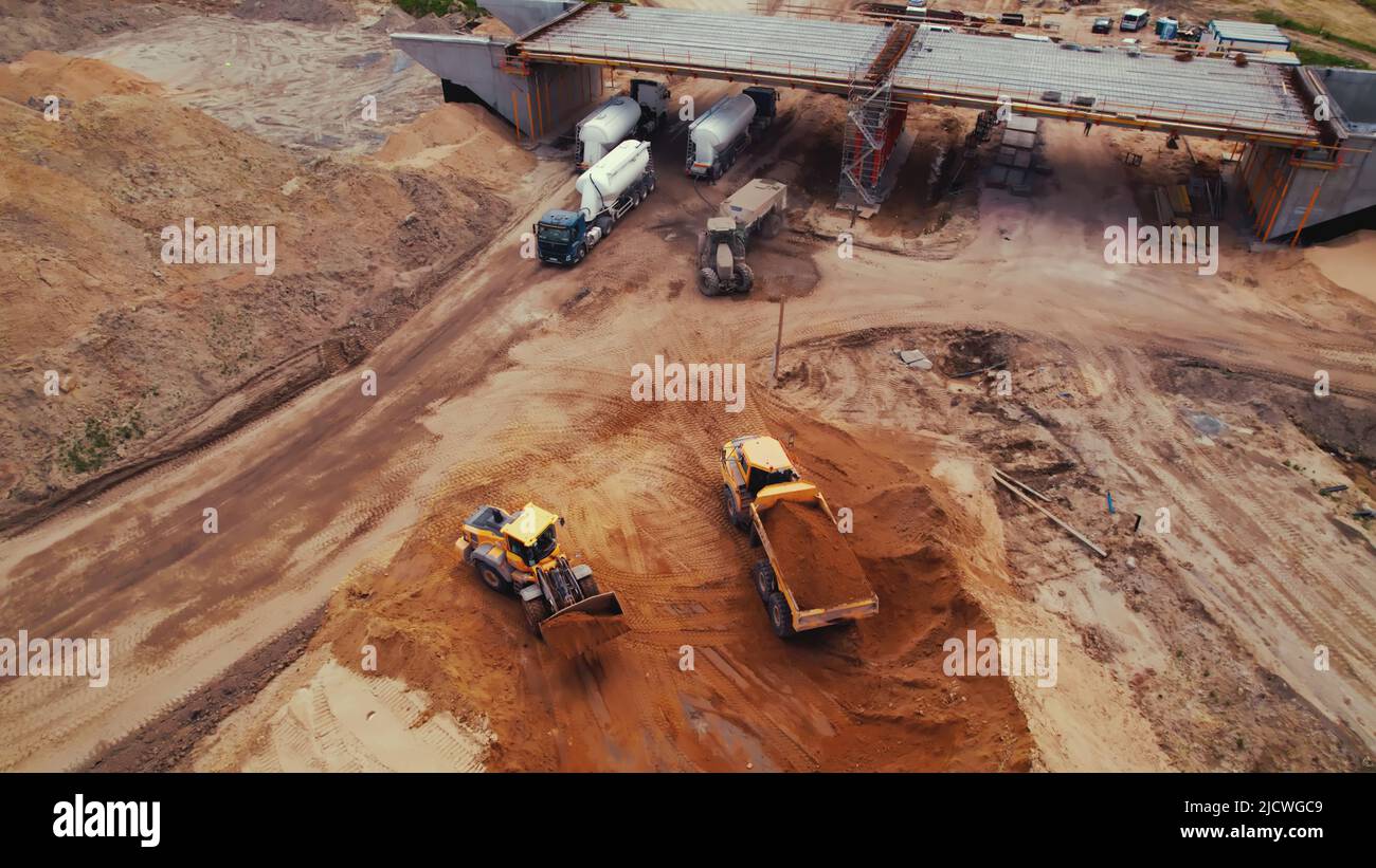 Aerial shot of a giant road construction site with a bridge and with a ...