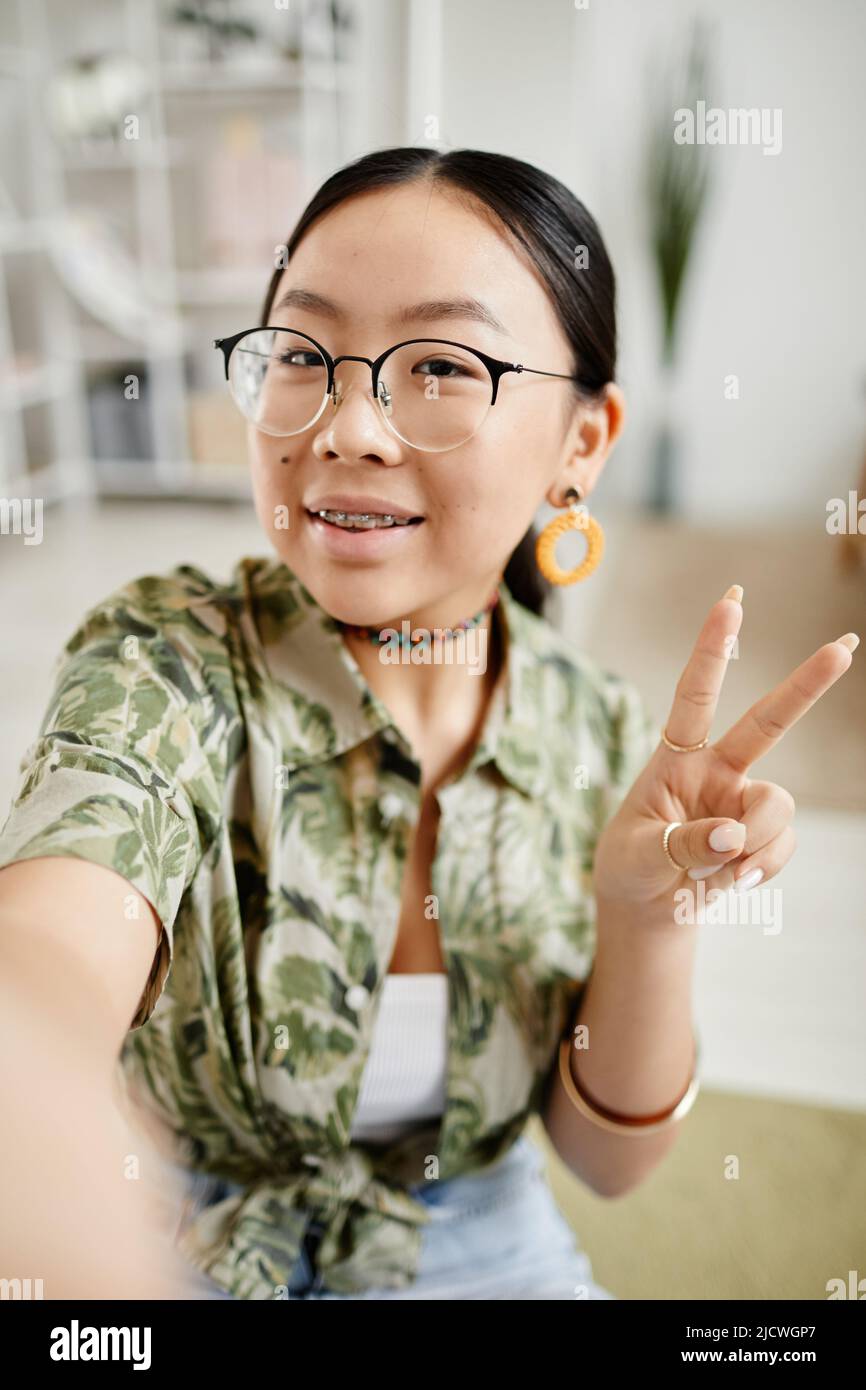 Vertical POV portrait of trendy teenage girl with braces smiling at ...