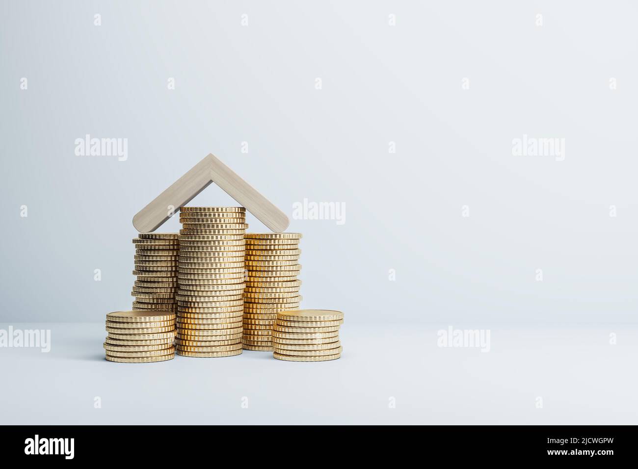 Real estate and protection concept with golden coin stacks under wooden ...