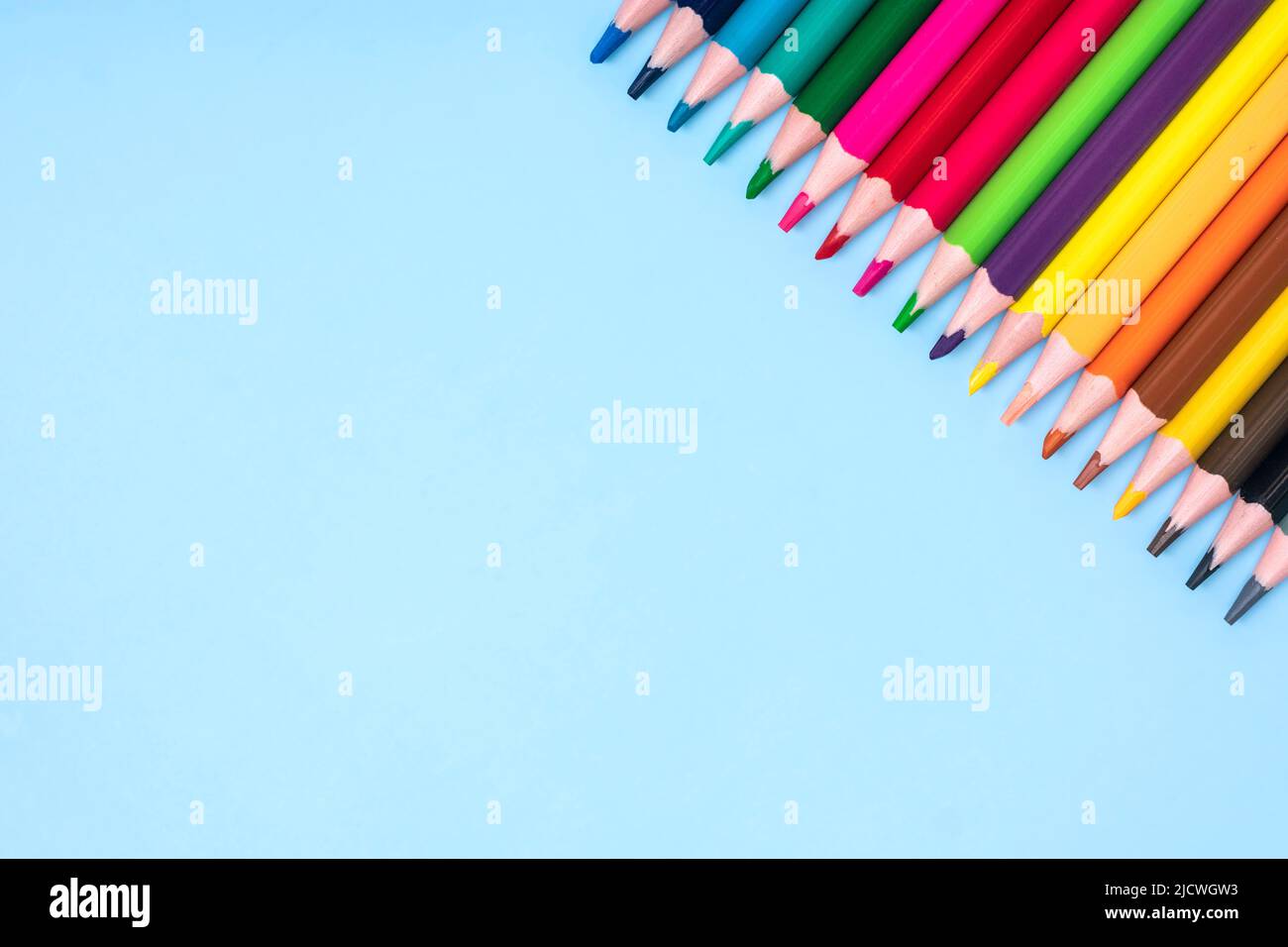 set of colored pencils isolated on blue background Top view Flat lay ...
