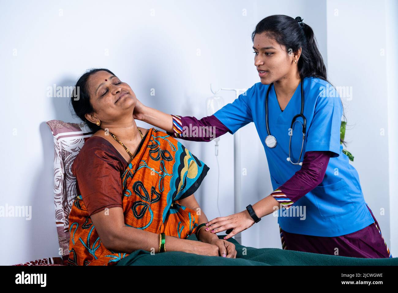 Indian nurse helping sick senior women hi-res stock photography and ...