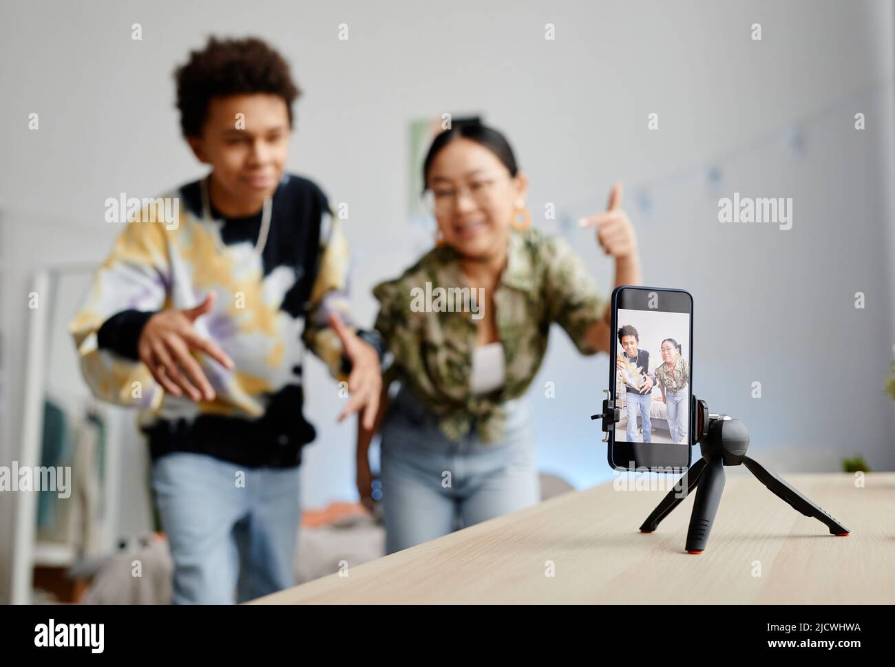 Background image of two gen Z teenagers filming video for social media ...