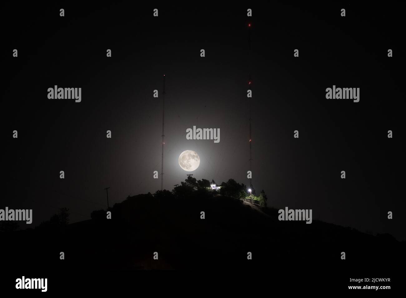 Super Full Moon over radio station on a hill Stock Photo - Alamy