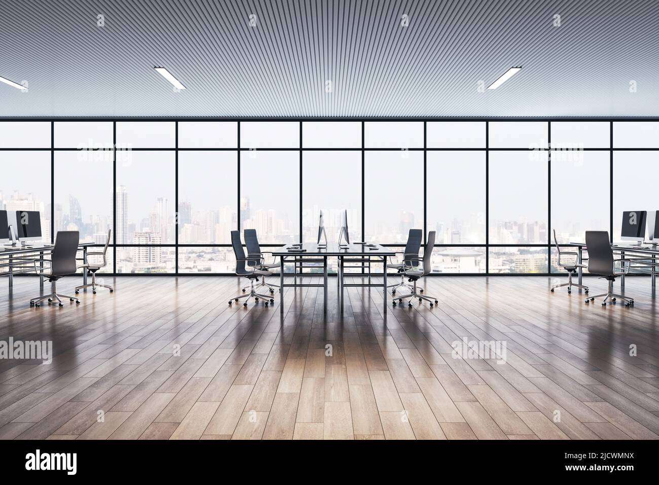 Front view on coworking work places in spacious office area with wooden ...