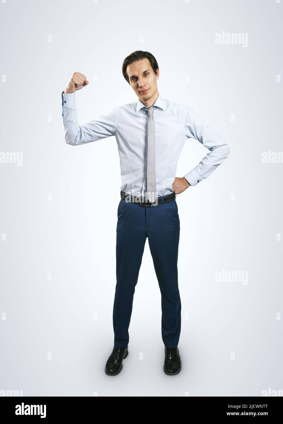 Buiness leader concept with young man in white shirt raising his hand ...