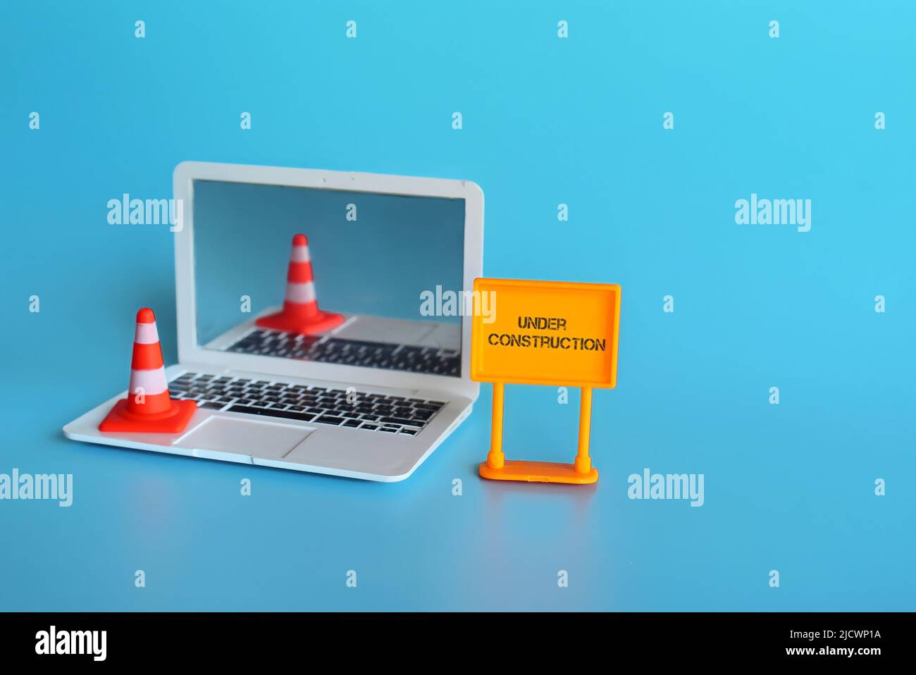 Website under construction concept. Laptop, safety cone and signboard ...