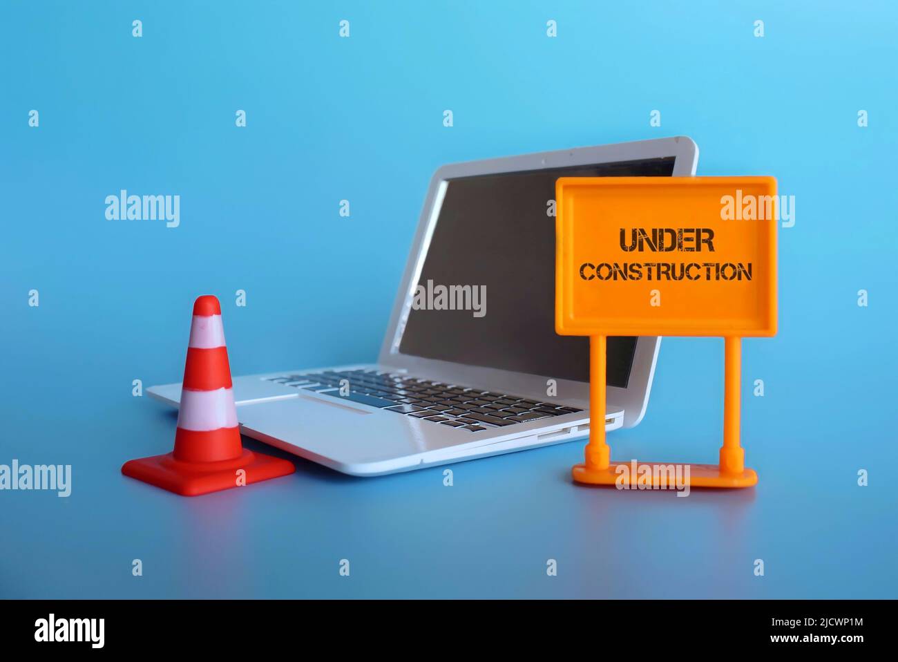 Website under construction concept. Laptop, safety cone and signboard ...
