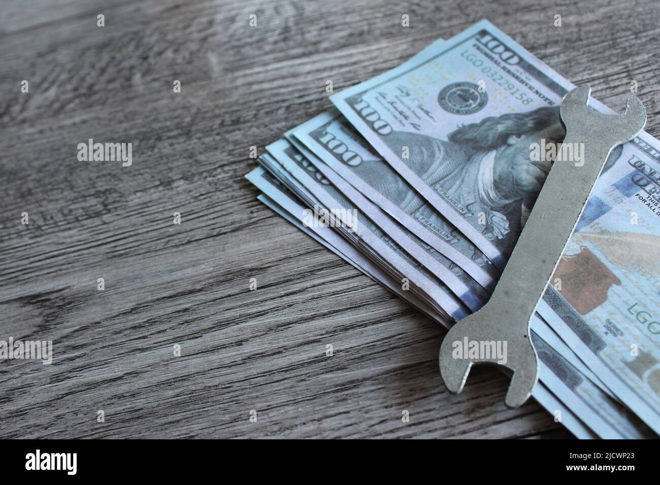 Spanner on top of money. Restoring, repair financial stability, service ...