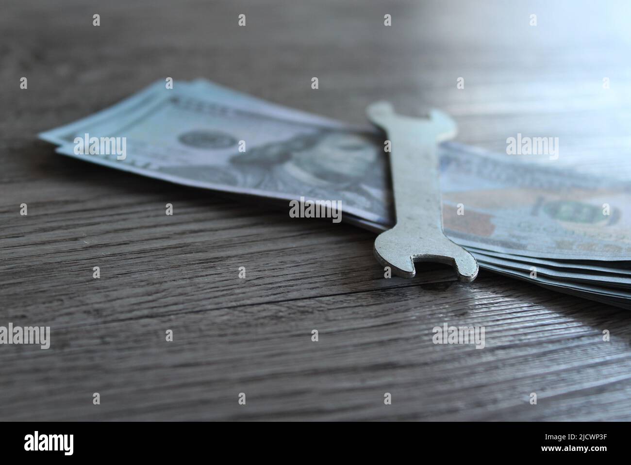 Spanner on top of money. Restoring, repair financial stability, service ...